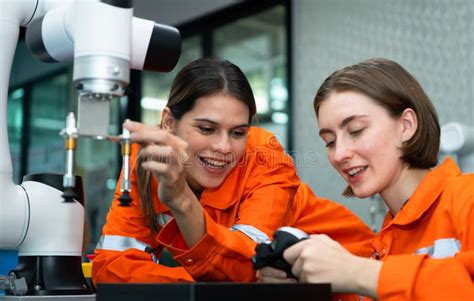 In An Electronic Parts Facility Two Female Engineers In The Plant Inspecting And Testing