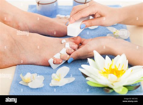 Cropped Image Of Pedicurist Filing Toenails Of Woman In Beauty Salon Stock Photo Alamy