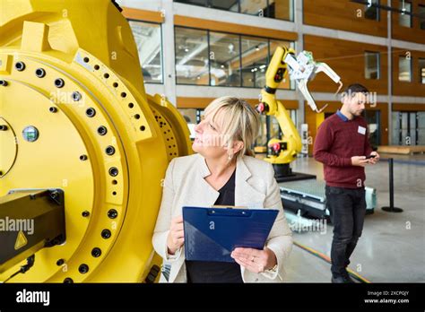engineers conducting inspections and programming robotic machinery in