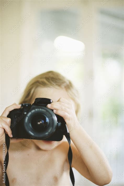 Stockfoto Young Nude Girl Taking A Picture With A Camera Adobe Stock