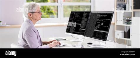 Programmer Woman Coding On Multiple Computer Screens Stock Photo Alamy