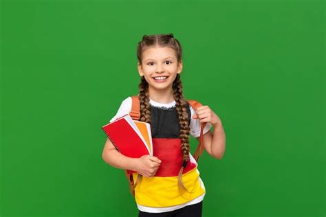 Premium Photo Learning German A Schoolgirl With A Textbook And An Image Of The German Flag On