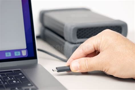 Hand Connecting A External Hard Disk To A Modern Laptop Computer Stock