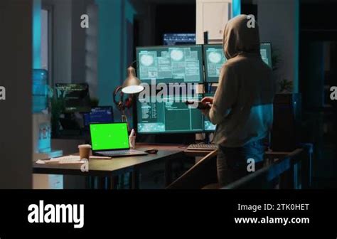 Male Hacker Using Greenscreen To Break Into It Server Coding And Programming On Multiple