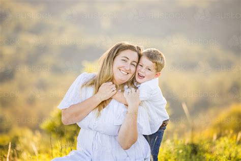 Image Of Mother And Son Embracing In Intimate Moment On Hilltop