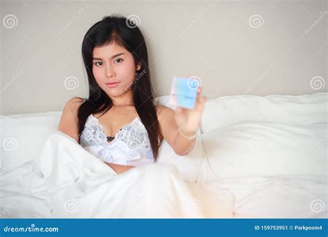 Young Woman Holding And Giving Condom Box In Her Hand Stock Image