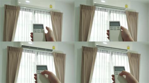 手按遥控器上的打开按钮启动空调冷却房间视频素材下载编号17478476光厂vj师网