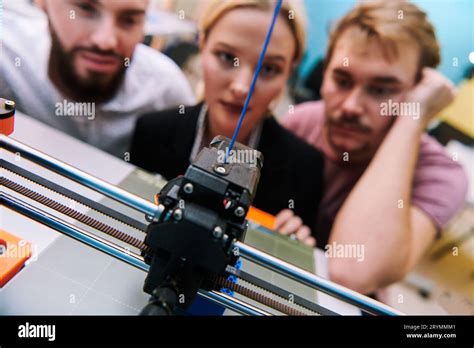 a group of colleagues working together in a robotics laboratory