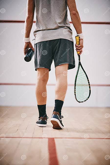 In A Squash League Of His Own An Unrecognisable Man Playing A Game Of