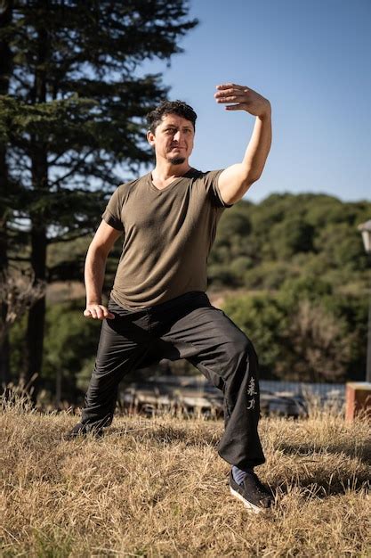 Caucasian Middleaged Man Practicing Tai Chi Chuan Outdoors Premium Photo