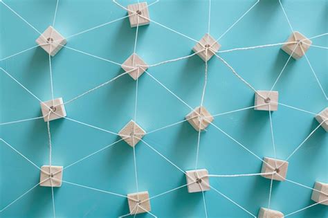 A Network Of Wooden Blocks With People S Faces On Them Connected By