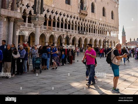 Tourists Queue To Enter The Basilico San Marco In Venice Italy Stock