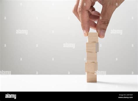 Stacking Up Five Wood Cubes In Vertical Stock Photo Alamy