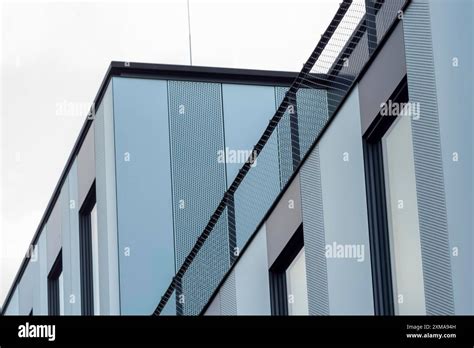 modern building facade with large windows and striking diagonal pattern
