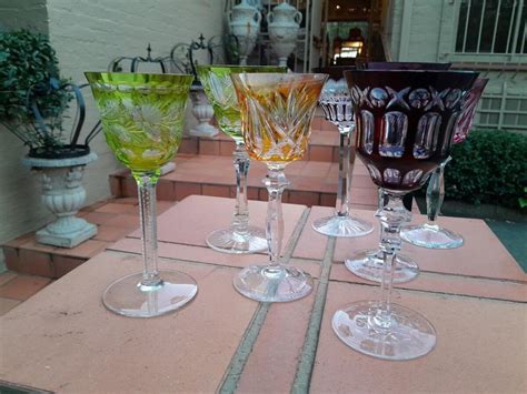 A 20th Century Collection Of Seven Coloured Bohemian Cut Crystal Wine Glasses The Crown Collection