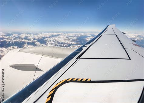 Clouds Mountains And Sky Seen Through Window Of An Aeroplane Wing And