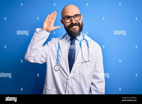 Handsome Bald Doctor Man With Beard Wearing Glasses And Stethoscope
