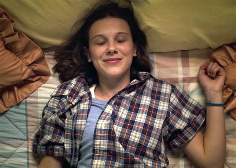 A Woman Laying In Bed With Her Eyes Closed