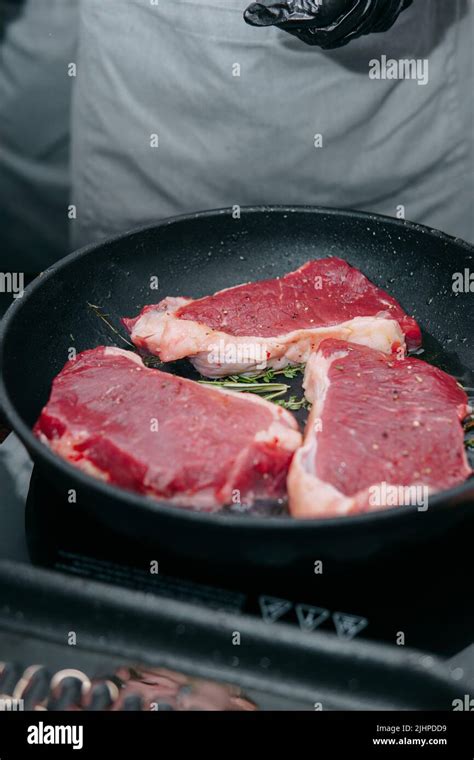 Cooking Steaks In A Pan Cooking Beef At The Culinary Master Class The Hands Of The Chef In