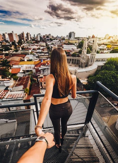 Free A Woman Leads The Viewer Through A Rooftop With A Stunning City