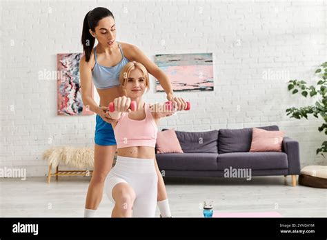 Two Young Women Enjoy A Workout Session Sharing Care And Motivation In