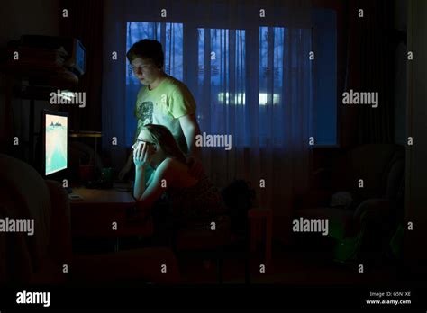 Caucasian Couple Using Computer At Night Stock Photo Alamy
