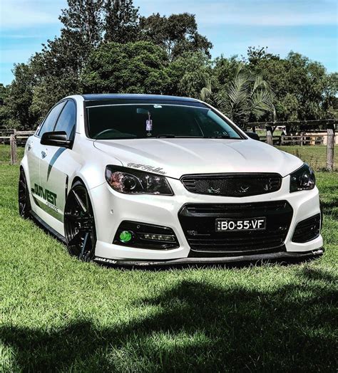 White Holden Commodore On Green Field
