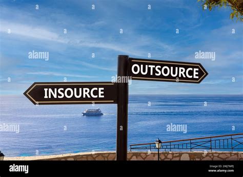 Outsource Or Insource Symbol Concept Word Outsource Or Insource On Beautiful Signpost With Two