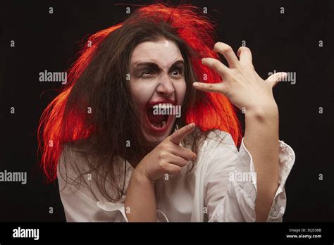 Fun Crazy Young Woman With Fluffy Hair On Black Background Make Grimace
