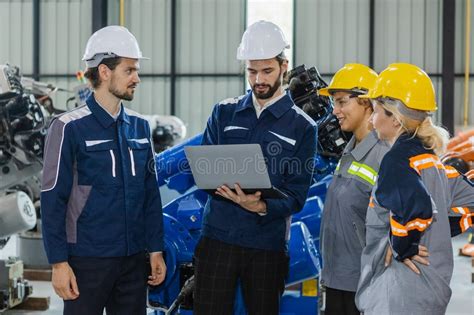 Engineers Working Robot Assembly Industry Plant In Factory Talking Meeting Examining