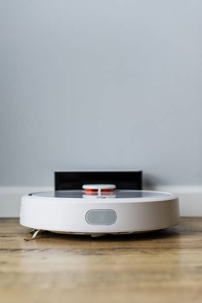 Premium Photo Robot Vacuum Cleaner On Wooden Floor Side View Smart