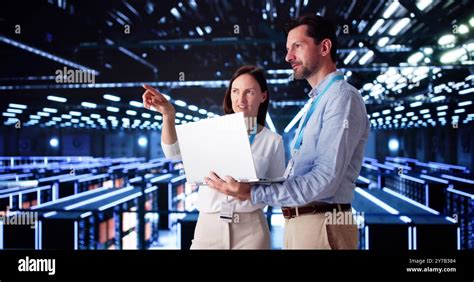 Server Room In Data Center Cloud Computer Engineers Configuring Ai