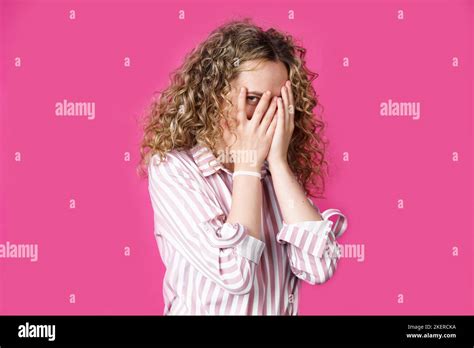 Portrait Of Shy Timid Or Ashamed Pretty Girl Covering Face And Peeping