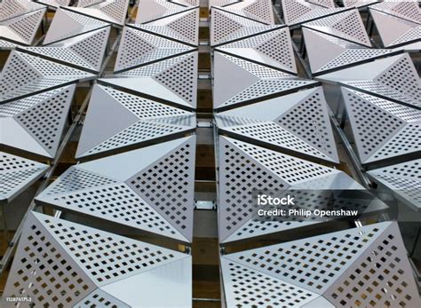 Modern Steel Angular Geometric Cladding In Perspective With Shiny Silver Colour And Perforated
