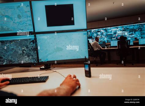 male security operator working in a data system control room offices