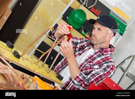 Man Connecting Copper Pipes Stock Photo Alamy
