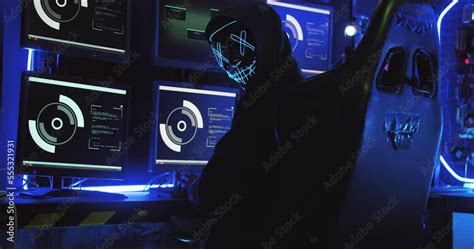 A Hacker Wearing A Mask To Cover His Face Is Using Computer To Hack Data To Get Ransom From
