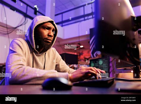 Concerned Hacker Cracking Password And Breaching Into Computer Network System Concentrated