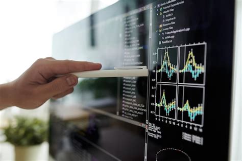 premium photo developer pointing at chart on screen