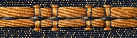 A Detailed Close Up Of Denim Fabric Showcasing Its Stitching Stock