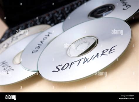 Piracy Concept Burnt CDs With Illegal Software On Keyboard Of