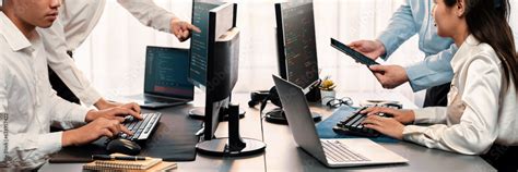 Software Development Team Working Together In Office Coding Script Display On Computer Monitor