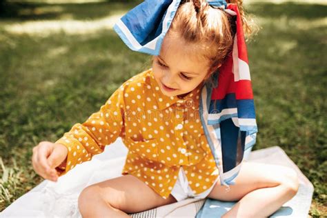 Image Of Happy Little Blond Girl Playing On The Blanketenjoying The