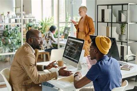 premium photo programmers discussing software on computer