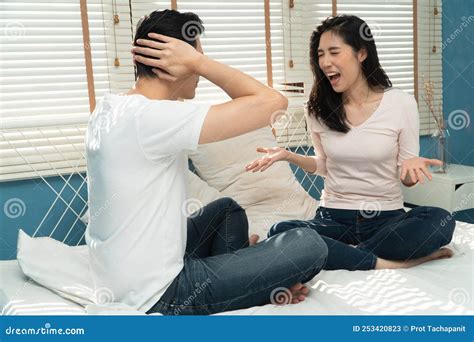 Unhappy Couple Sitting Beside Each Other On The Floor And Avoid Talking