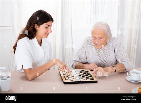 Two Women Playing Checkers Game Stock Photo Alamy