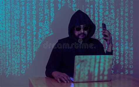 A Hacker Uses A Malware With Mobile Phone And Laptop To Hack Password The Personal Data And