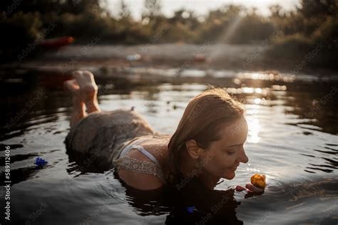 Beautiful Young Woman In Lake Water In Summer Dress At Sunset Portrait