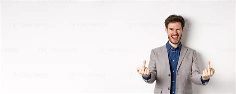 Rude Ignorant Guy In Business Suit Showing Middle Fingers And Tongue Smiling While Mocking