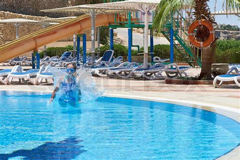 Babe Girl Jumping Into Swimming Pool Stock Image Colourbox